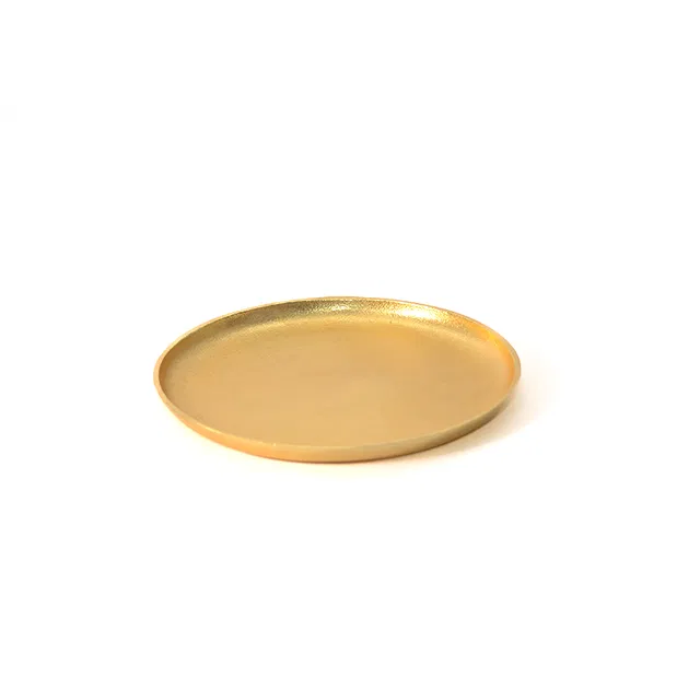 A medium golden round serving plate